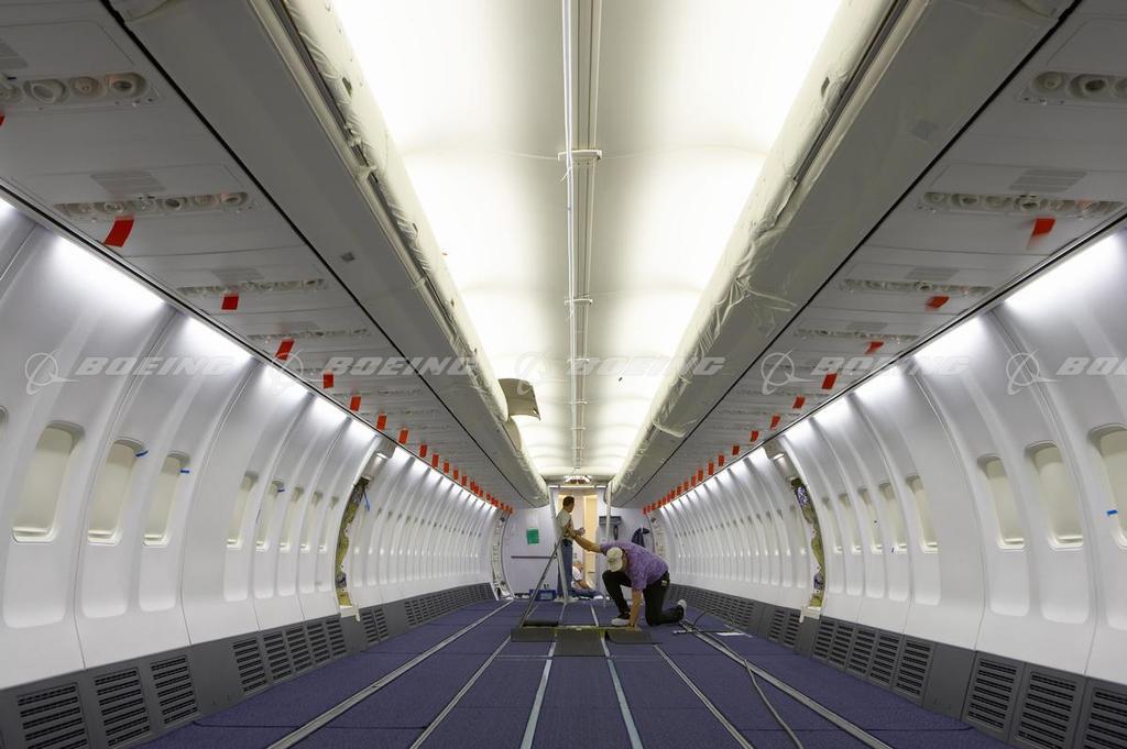 Boeing Images - Factory Workers Installing Carpet on a 737