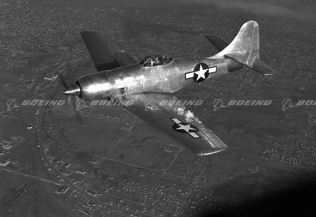 Boeing Images - Unpainted XF8B-1 in Flight over Suburbs