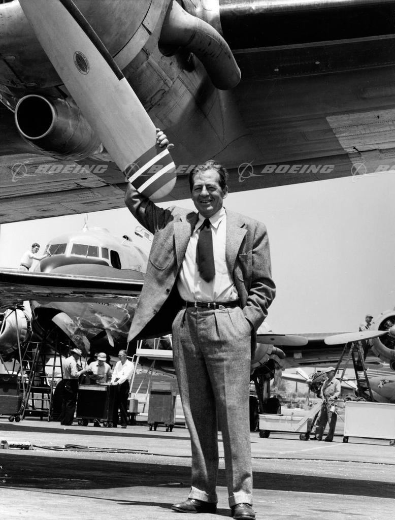 Boeing Images - Donald Wills Douglas Sr. Leans on the Prop of a New DC-7