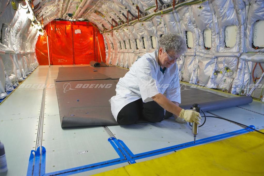 Boeing Images - Factory Worker Drilling Floor Panels Inside a 737 Fuselage