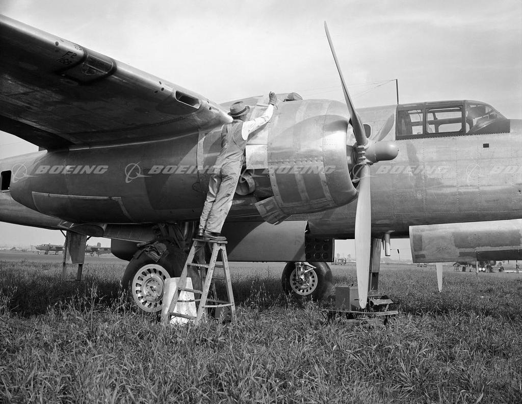 Boeing Images - Mechanic Working on the Engine of a B-25 Mitchell