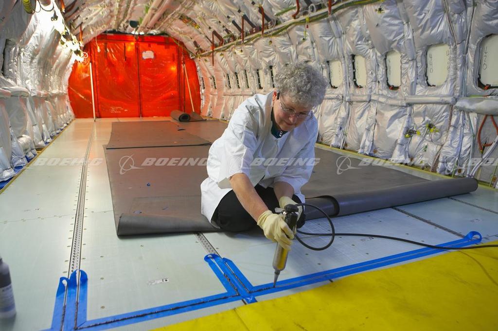 Boeing Images - Factory Worker Drilling Floor Panels Inside a 737 Fuselage