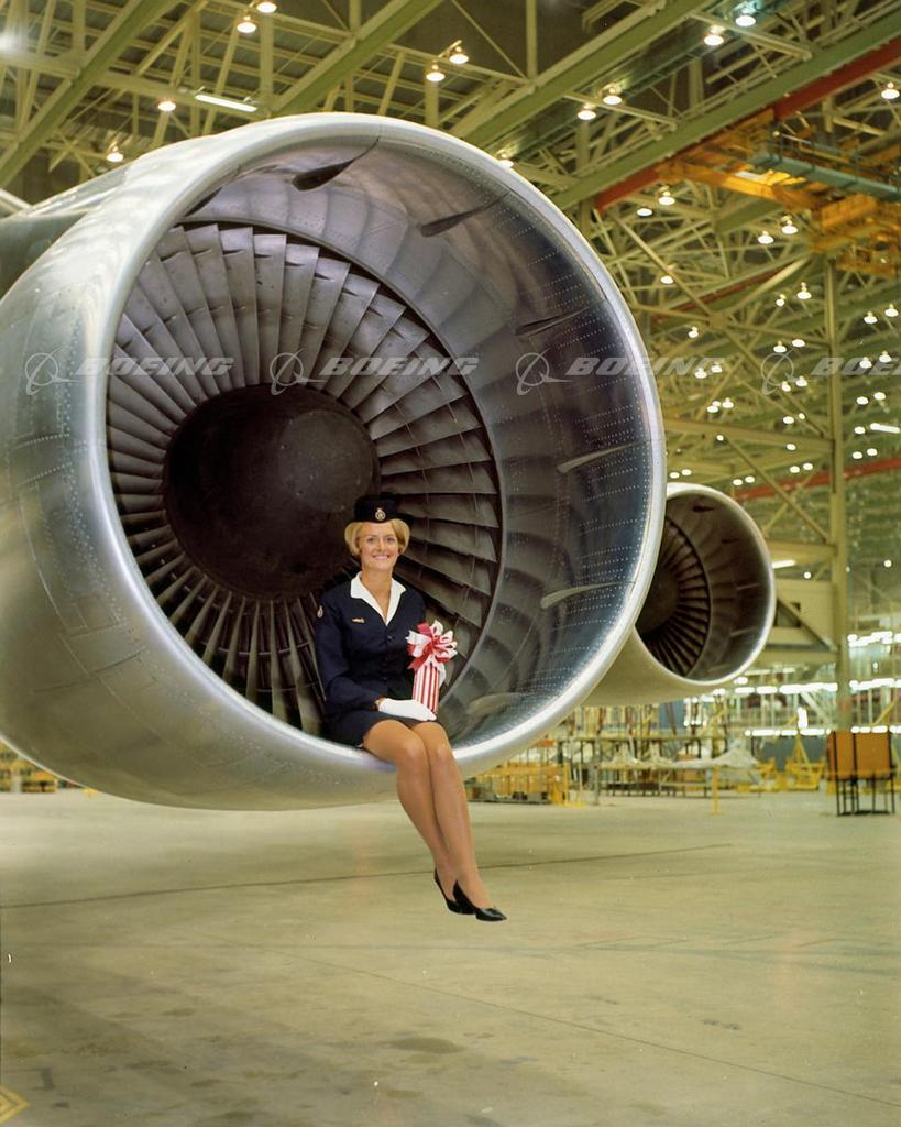 Boeing Images - BOAC Flight Attendant Sits on the Cowling of a 747 Engine