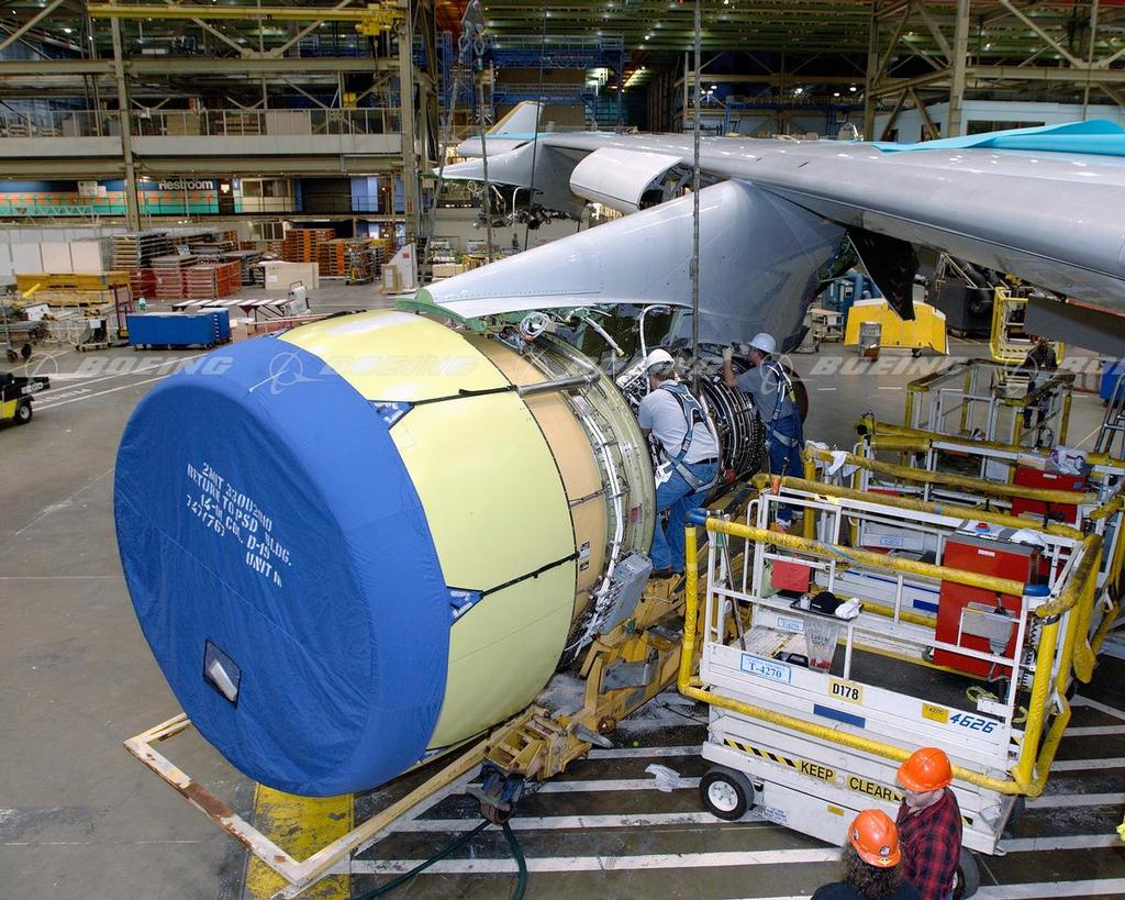 Boeing Images - Workers Attach an Inboard Engine on a 747-400.
