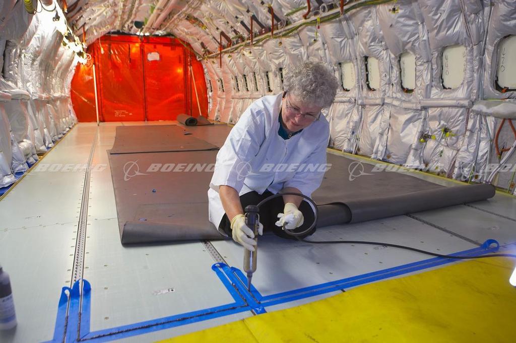 Boeing Images - Factory Worker Drilling Floor Panels Inside a 737 Fuselage
