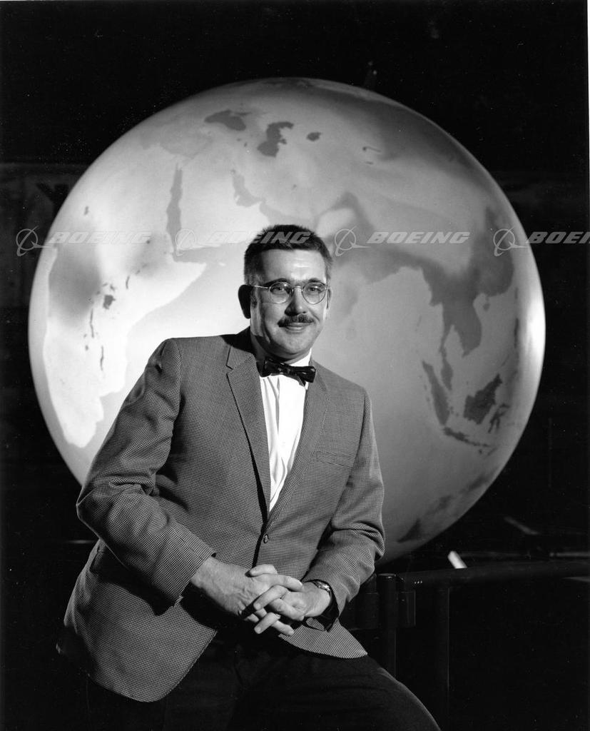 Boeing Images - George Stoner Poses in front of a Globe