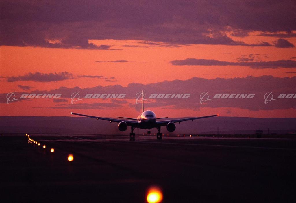 Boeing Images - 777 Taxiing Alongside Runway Lights at Sunset