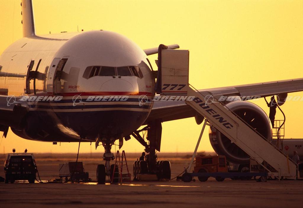 Boeing Images - 777 with Passenger Boarding Stairs in Sunset